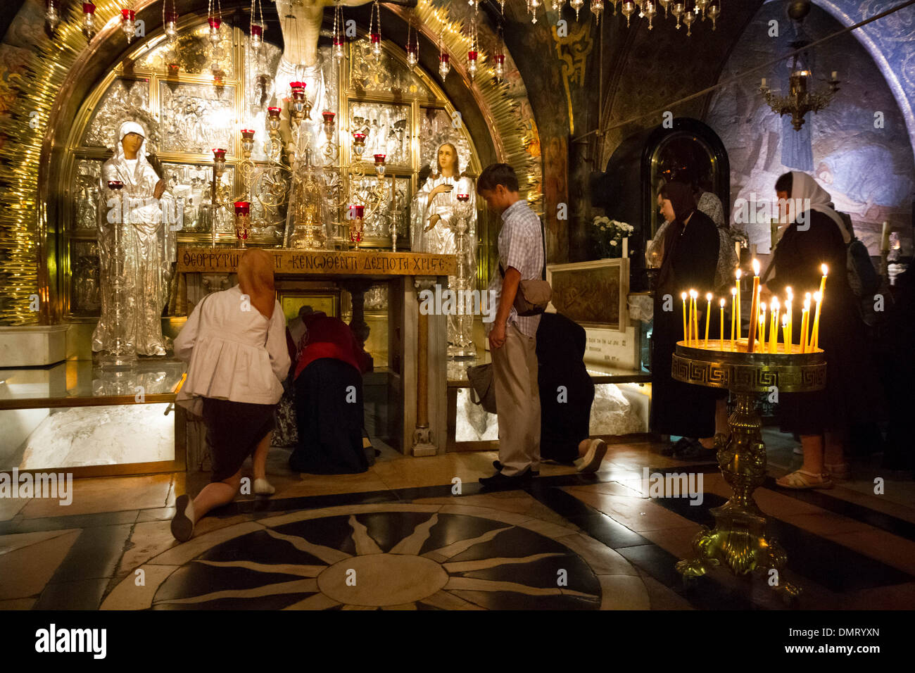 Christian pilgrims queue on their knees preparing to touch and pray ...
