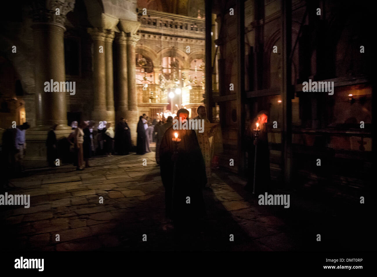 Orthodox Christian priests performing a night liturgy around the ...