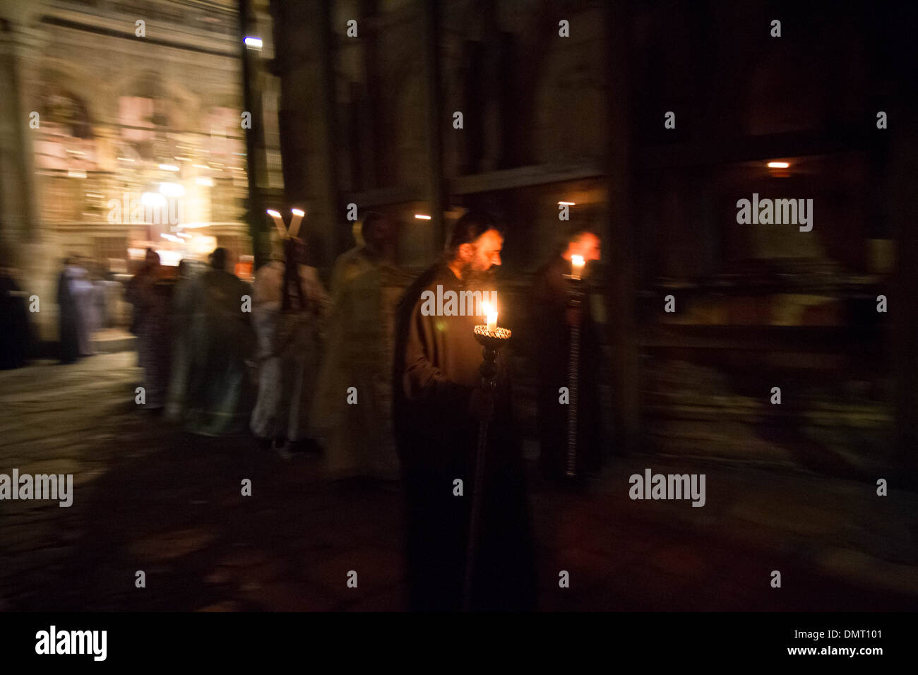 Orthodox Christian priests performing a night liturgy around the ...