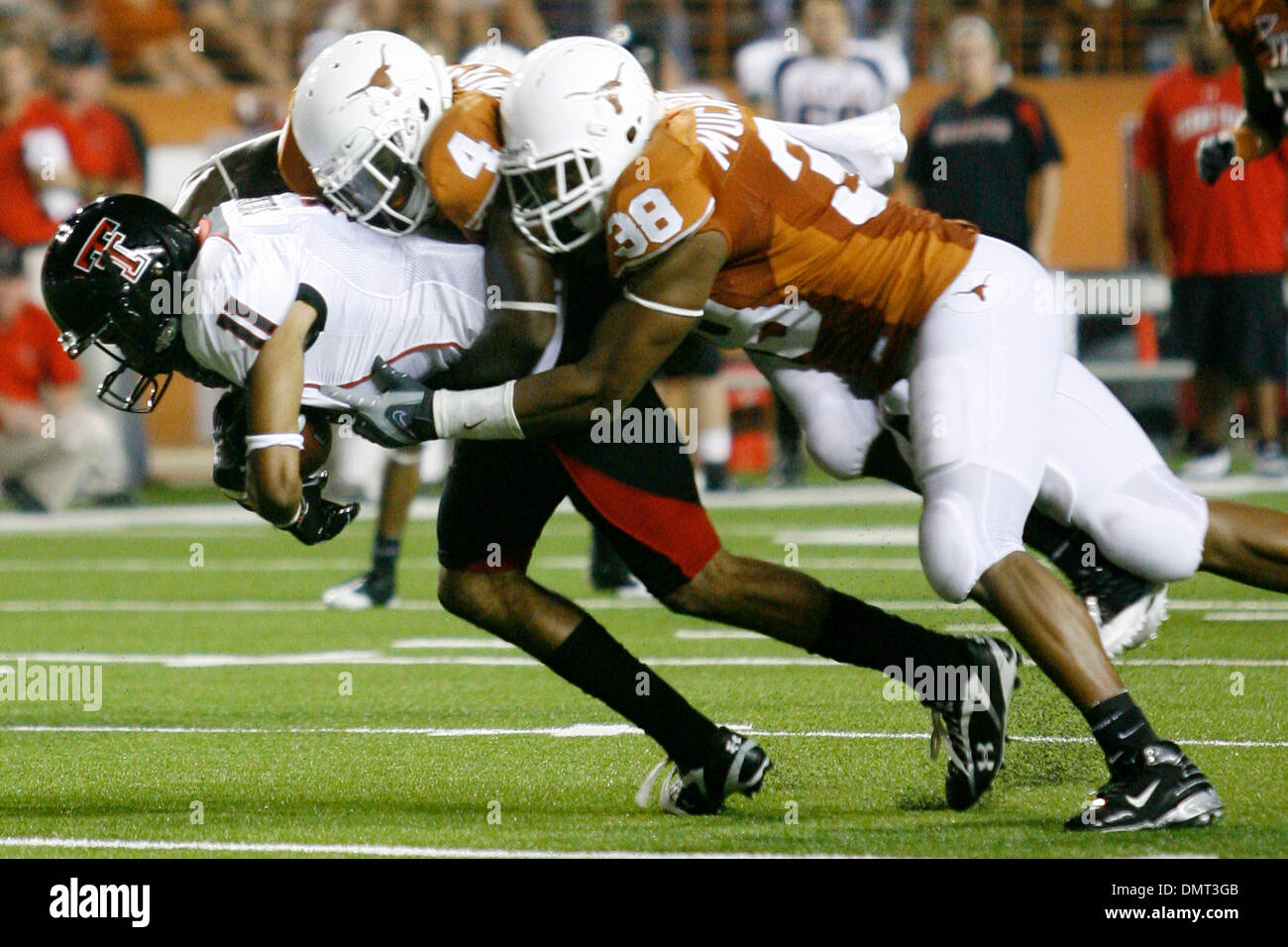 Texas's Roddrick Muckleroy (38) and Aaron Williams (4) bring down Texas ...