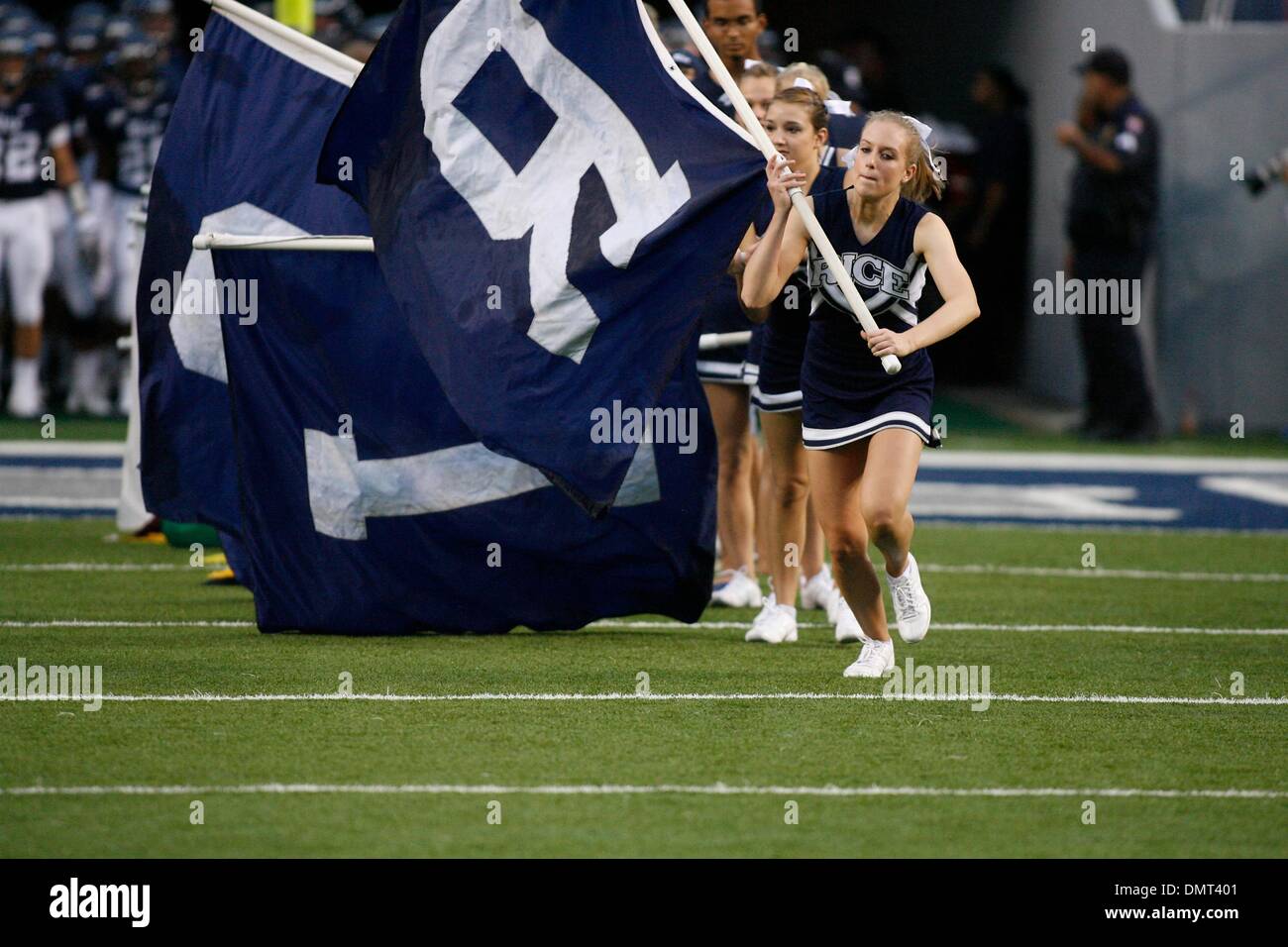 Rice cheerleaders holding the Rice flag before the game. The Tulsa ...