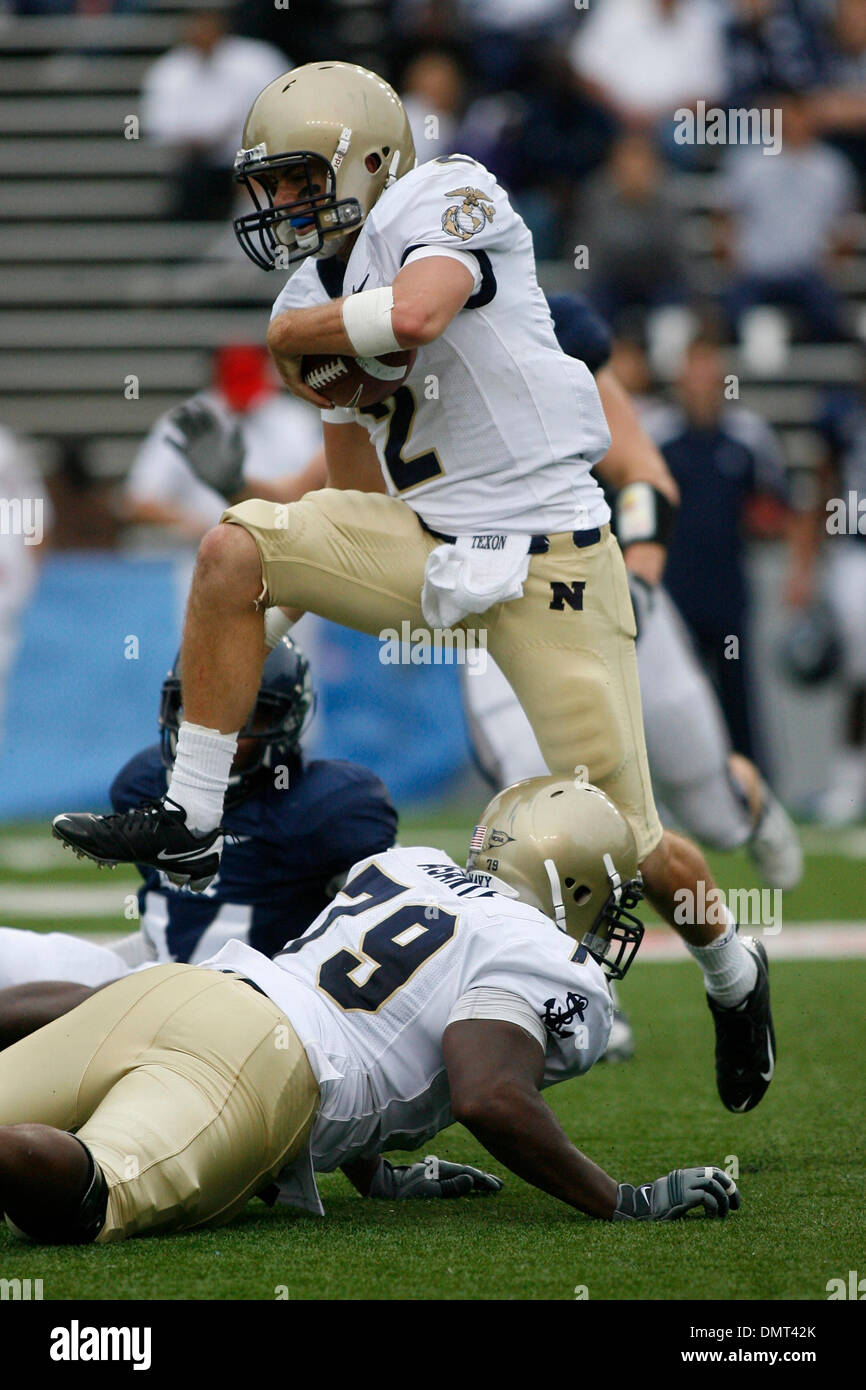 Navy quarterback Kriss Proctor (2) hurdles the linesman in the second ...
