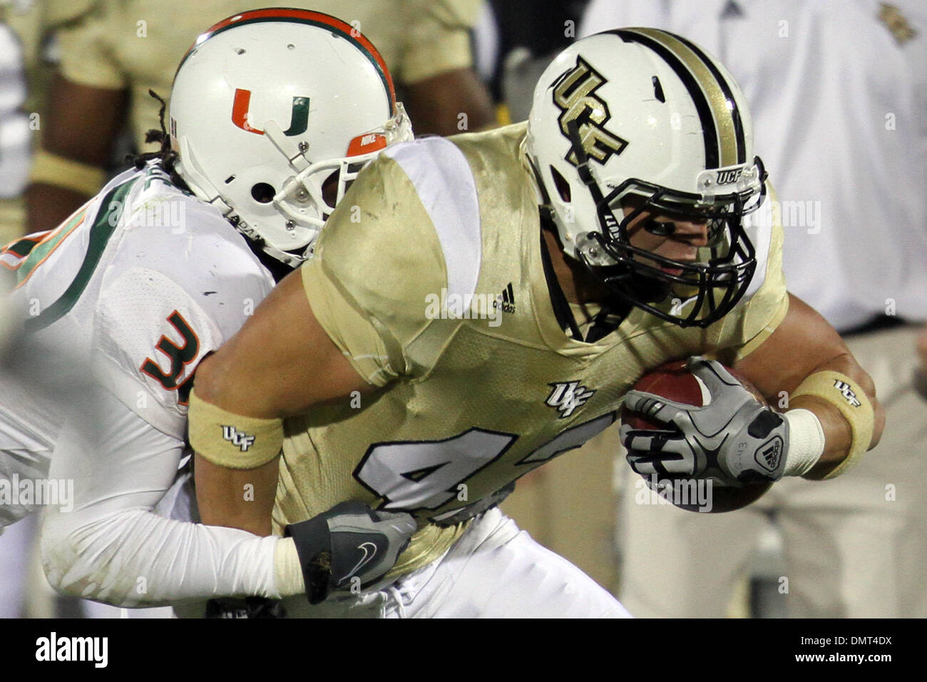 UCF running back Ricky Kay (43) attempts to escape a tackle from Miami ...