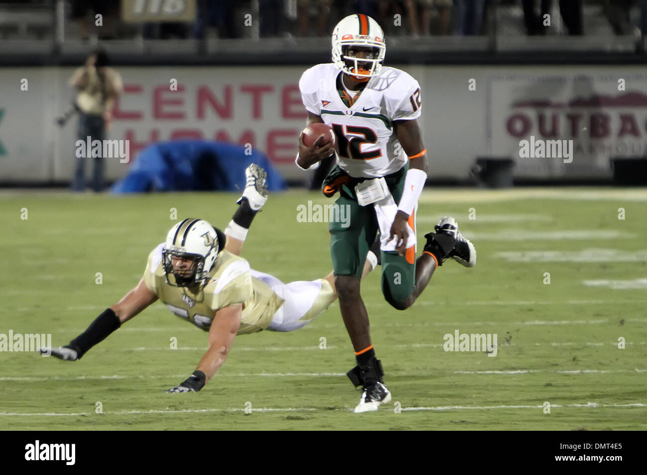 Miami (FL) quarterback Jacory Harris (12) runs for a first down between ...