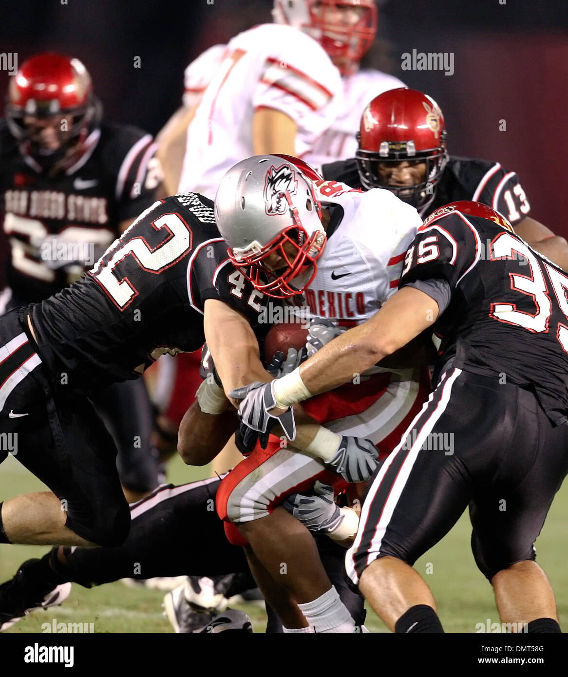 New Mexico Lobo Kasey Carrier (21) runs into an Aztec wall of defense ...