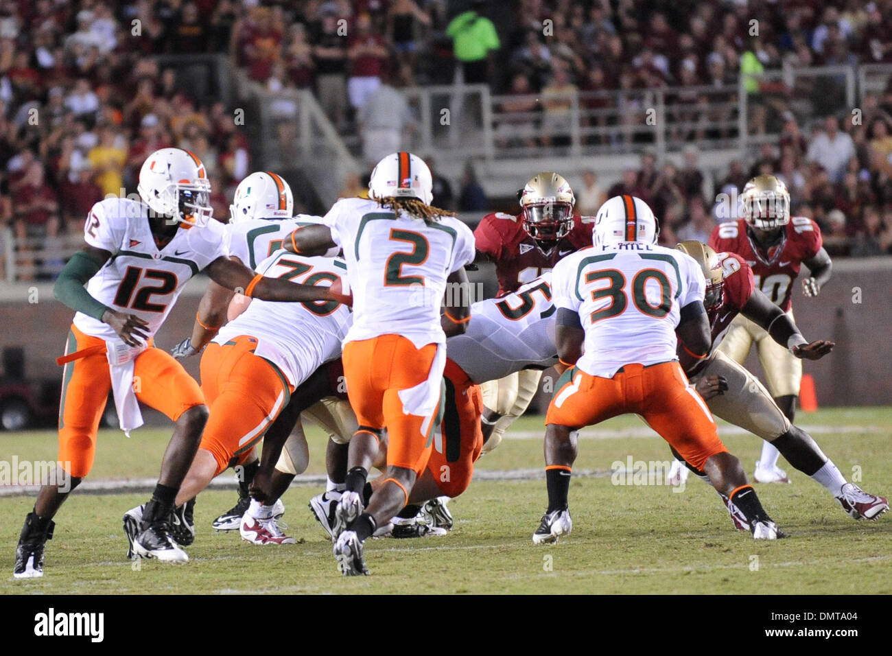 Miami running, Graig Cooper, takes the hand off from quarterback Jacory ...