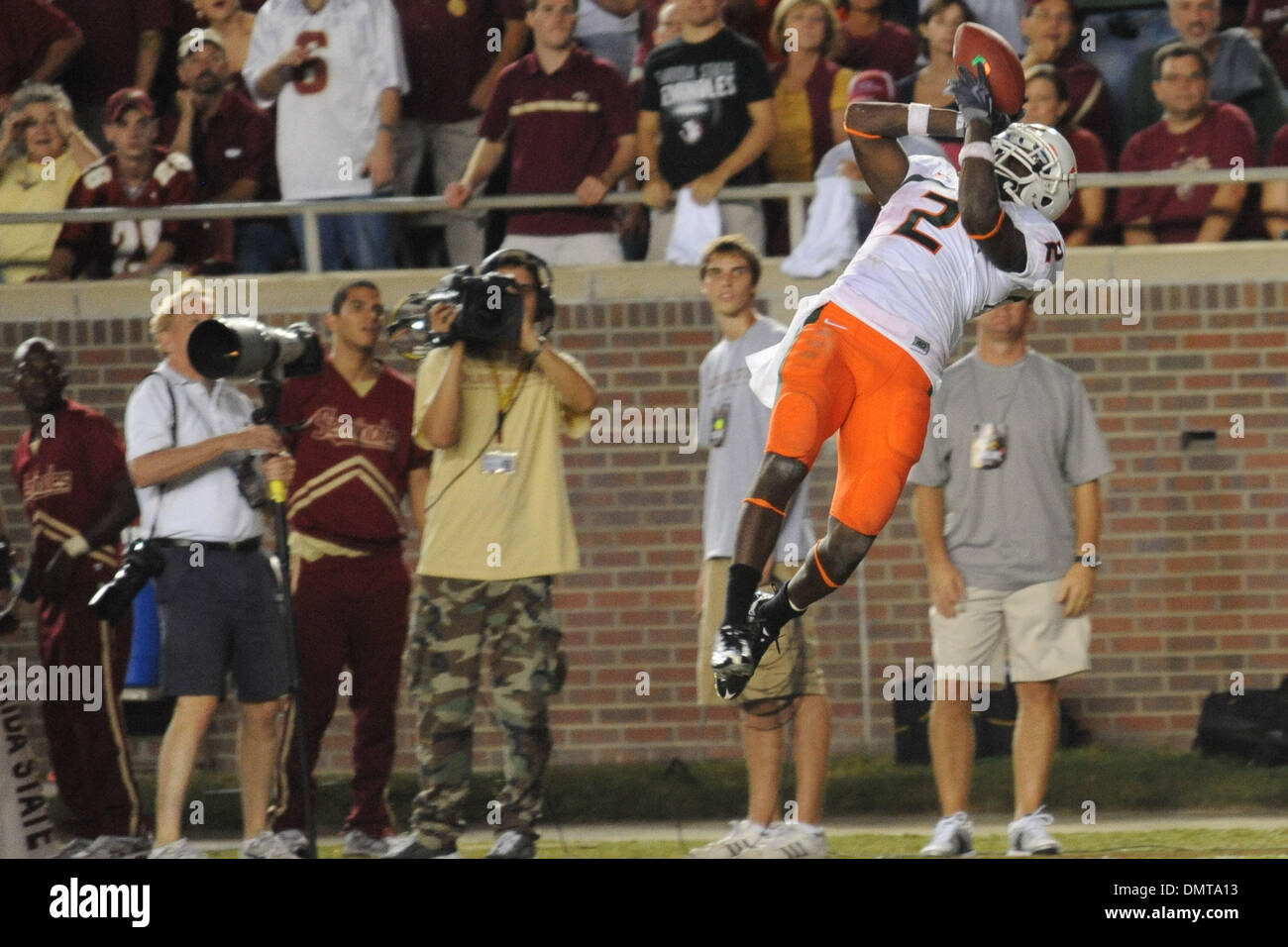 Miami running back, Graig Cooper, makes a leaping catch for a touchdown ...