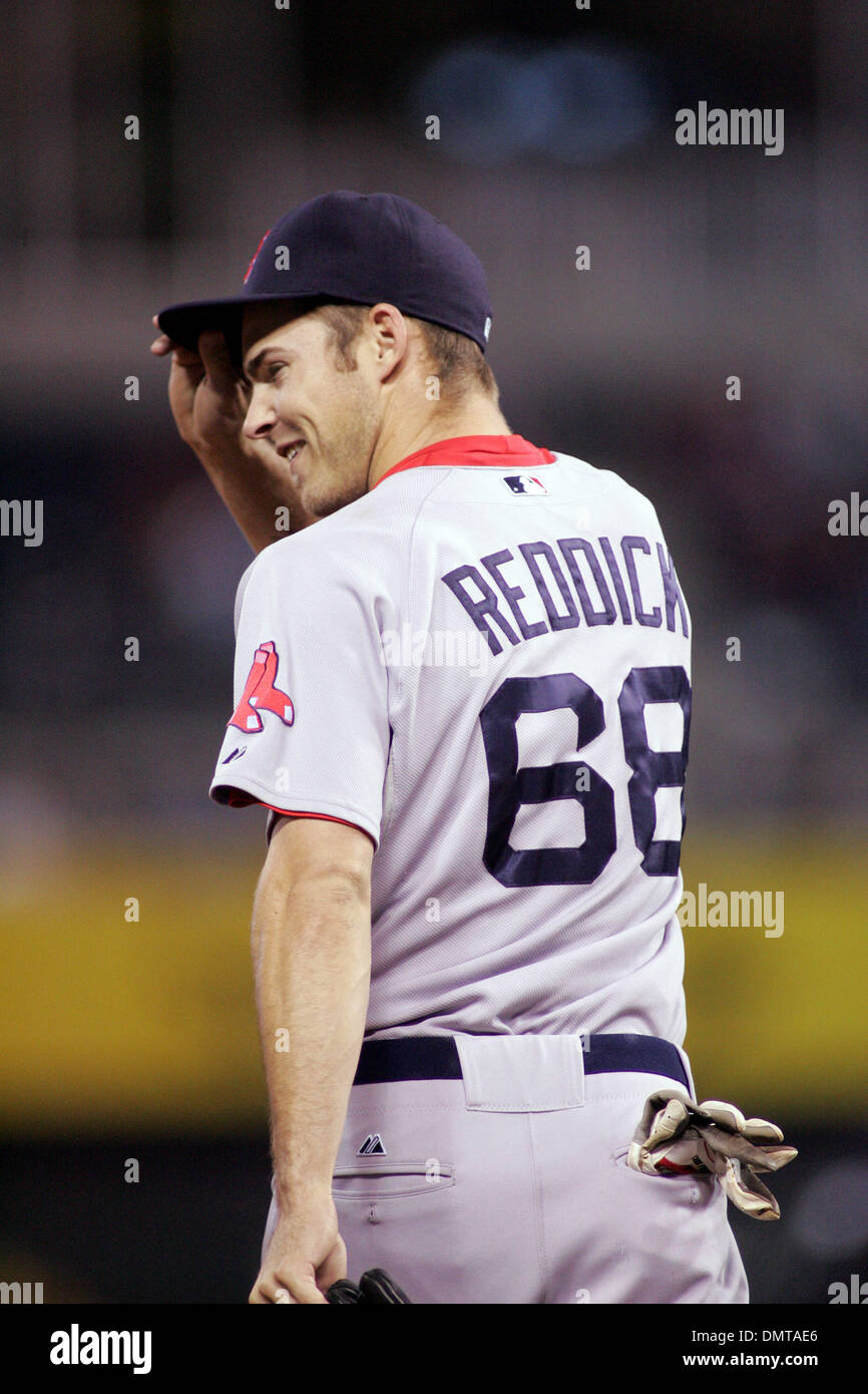 Boston Red Sox left fielder Josh Reddick puts on his hat while walking ...