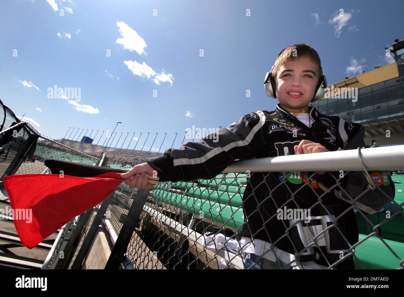 A young Kyle Busch fan waves his flag as cars pass by during Price ...