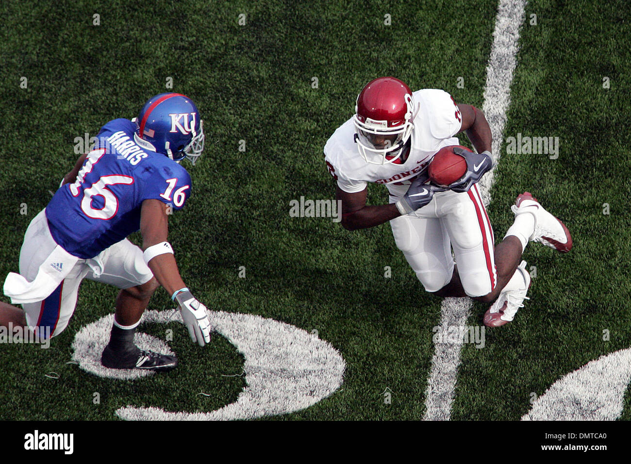 Kansas cornerback Chris Harris (16) attempts to take down Oklahoma wide ...