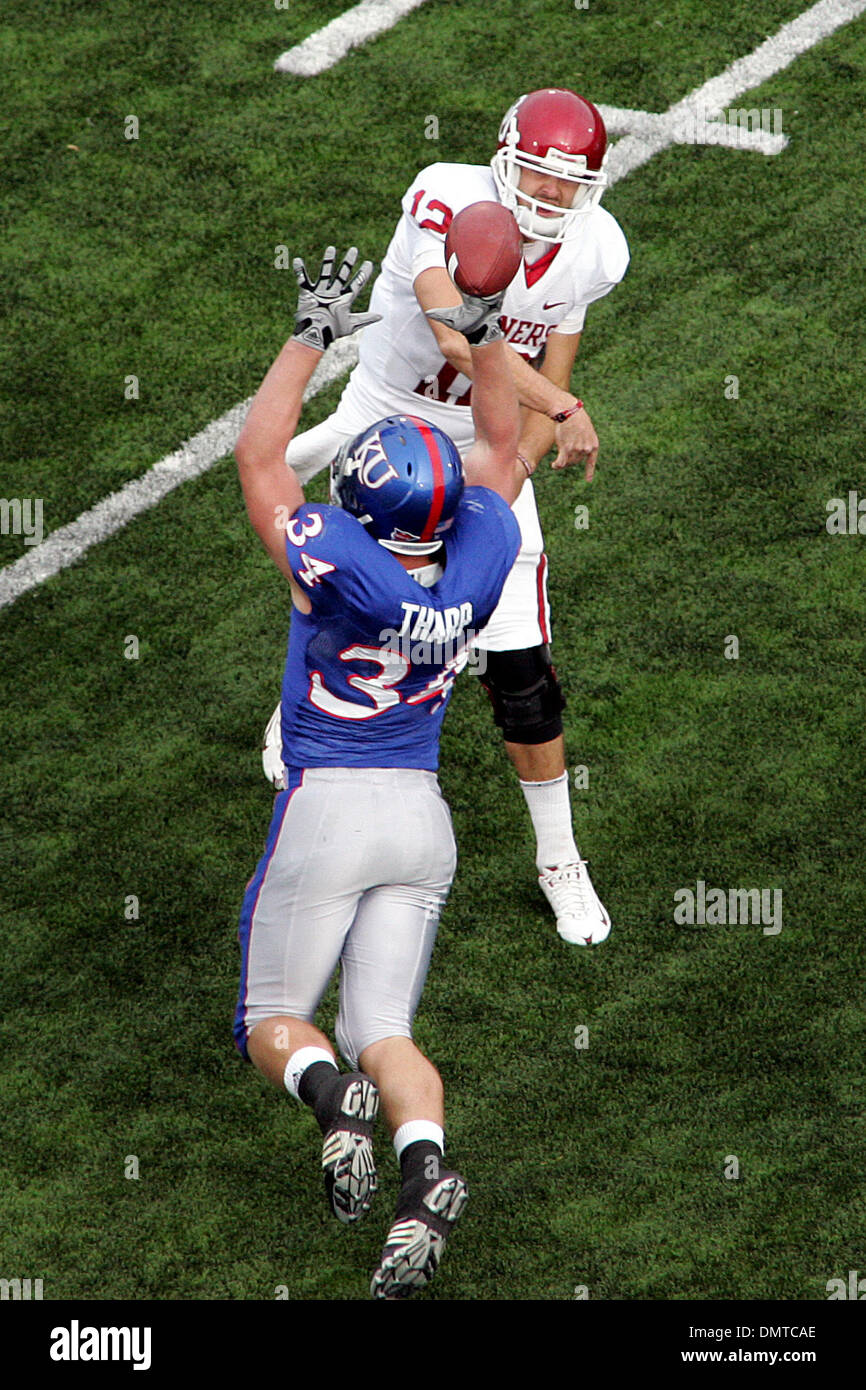 Oklahoma quarterback Landry Jones (12) passes over Kansas linebacker ...