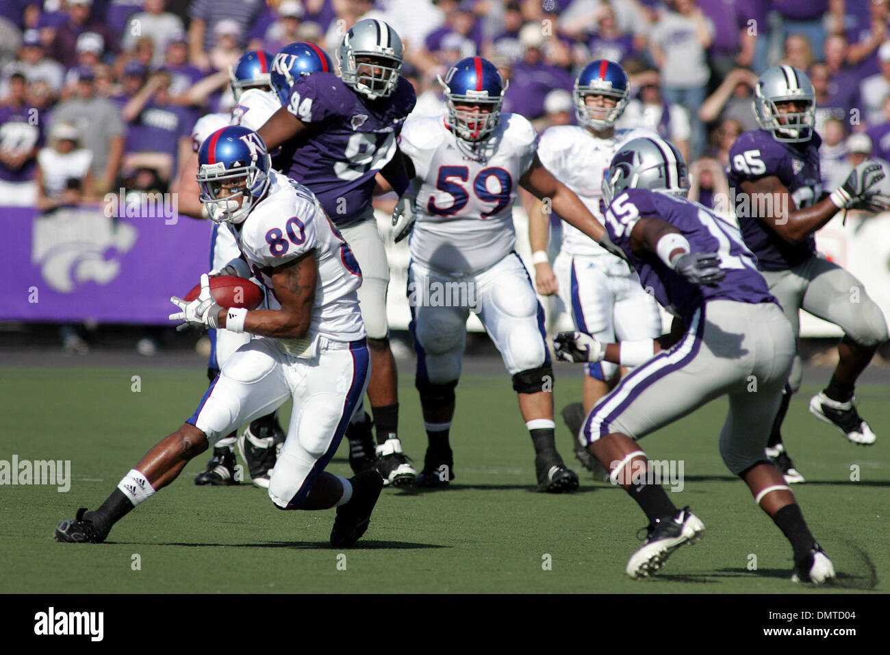 Kansas wide receiver Dezmon Briscoe (80) dodges Kansas State defensive ...