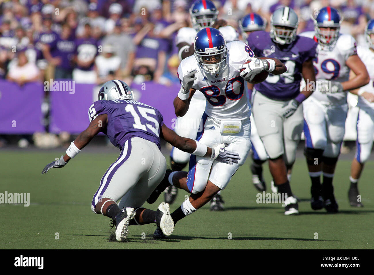 Kansas wide receiver Dezmon Briscoe (80) dodges Kansas State defensive ...
