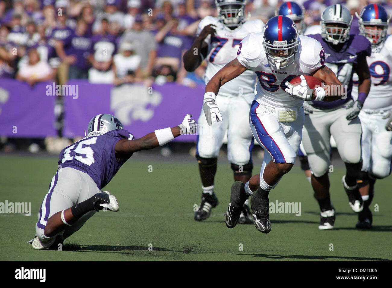 Kansas wide receiver Dezmon Briscoe (80) dodges Kansas State defensive ...