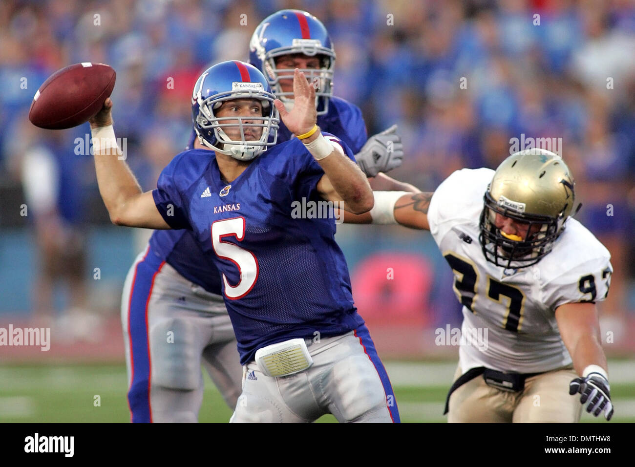 Kansas quarterback Todd Reesing (5) looks to pass under heavy coverage ...