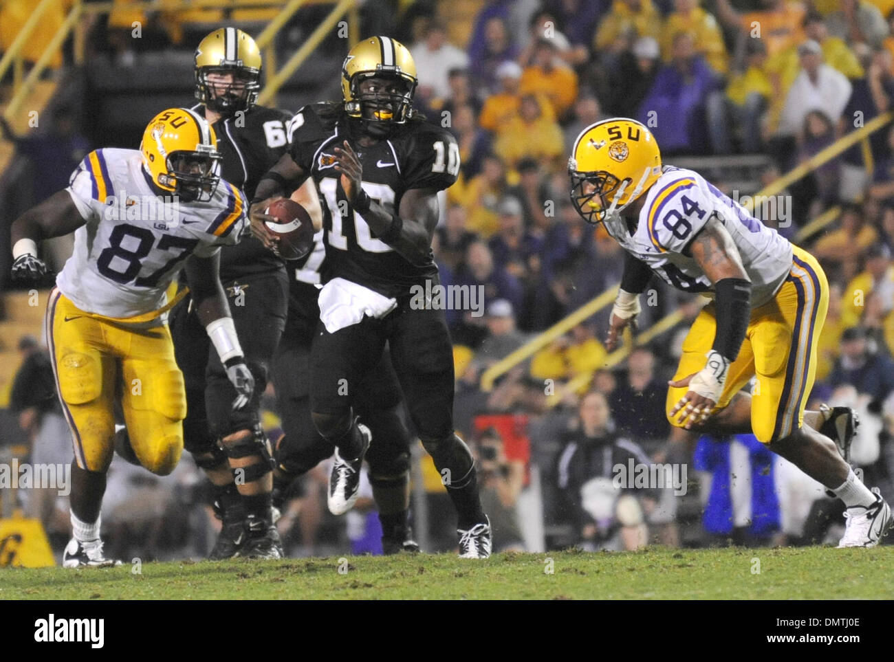 Vanderbilt quarterback, Larry Smith, eludes LSU defensive players ...