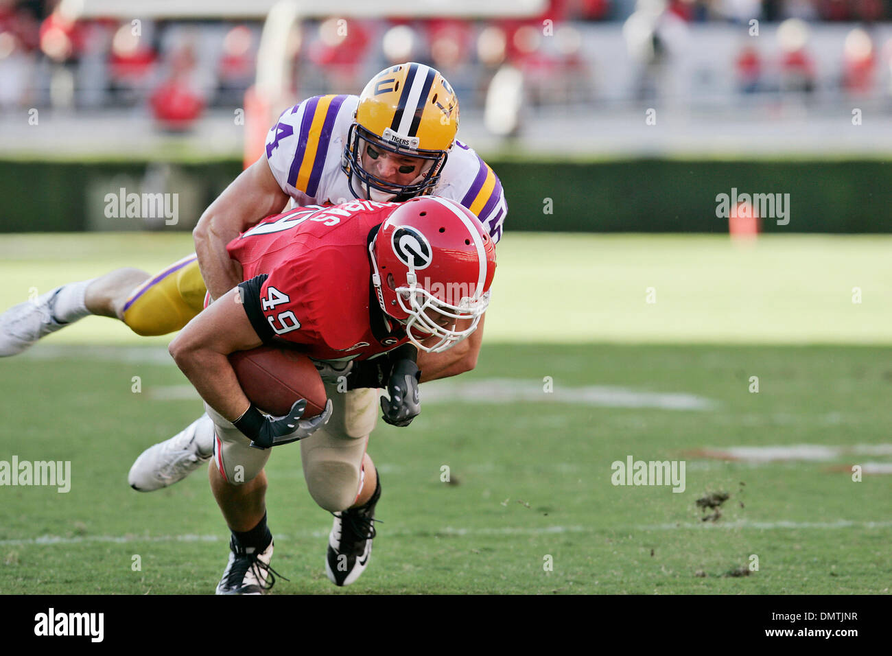 LSU linebacker Jacob Cutrera (54) tackles Georgia fullback Shaun Chapas ...