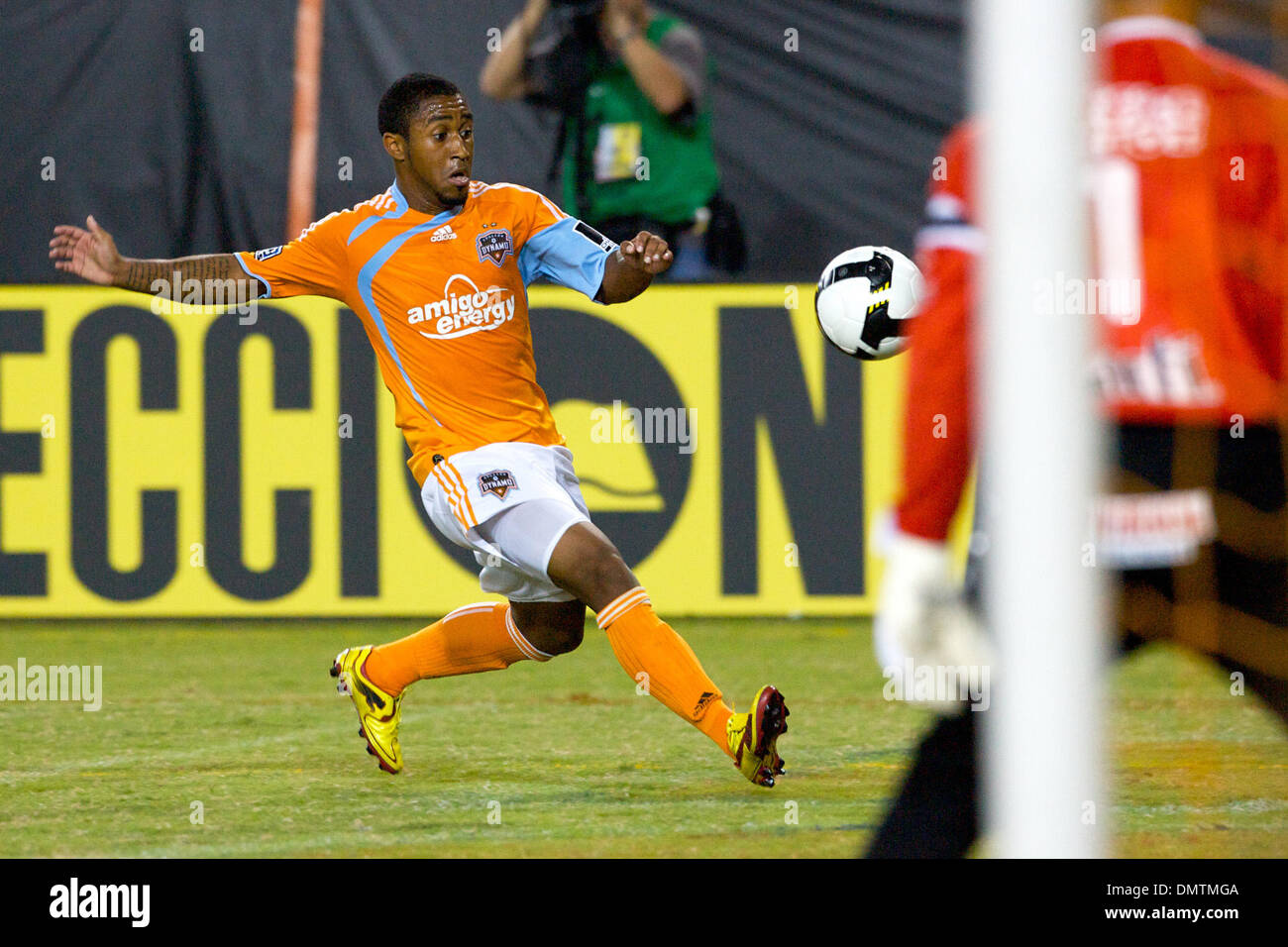 Corey Ashe (#26) Midfielder of the Houston Dynamo shoots on goal from a ...