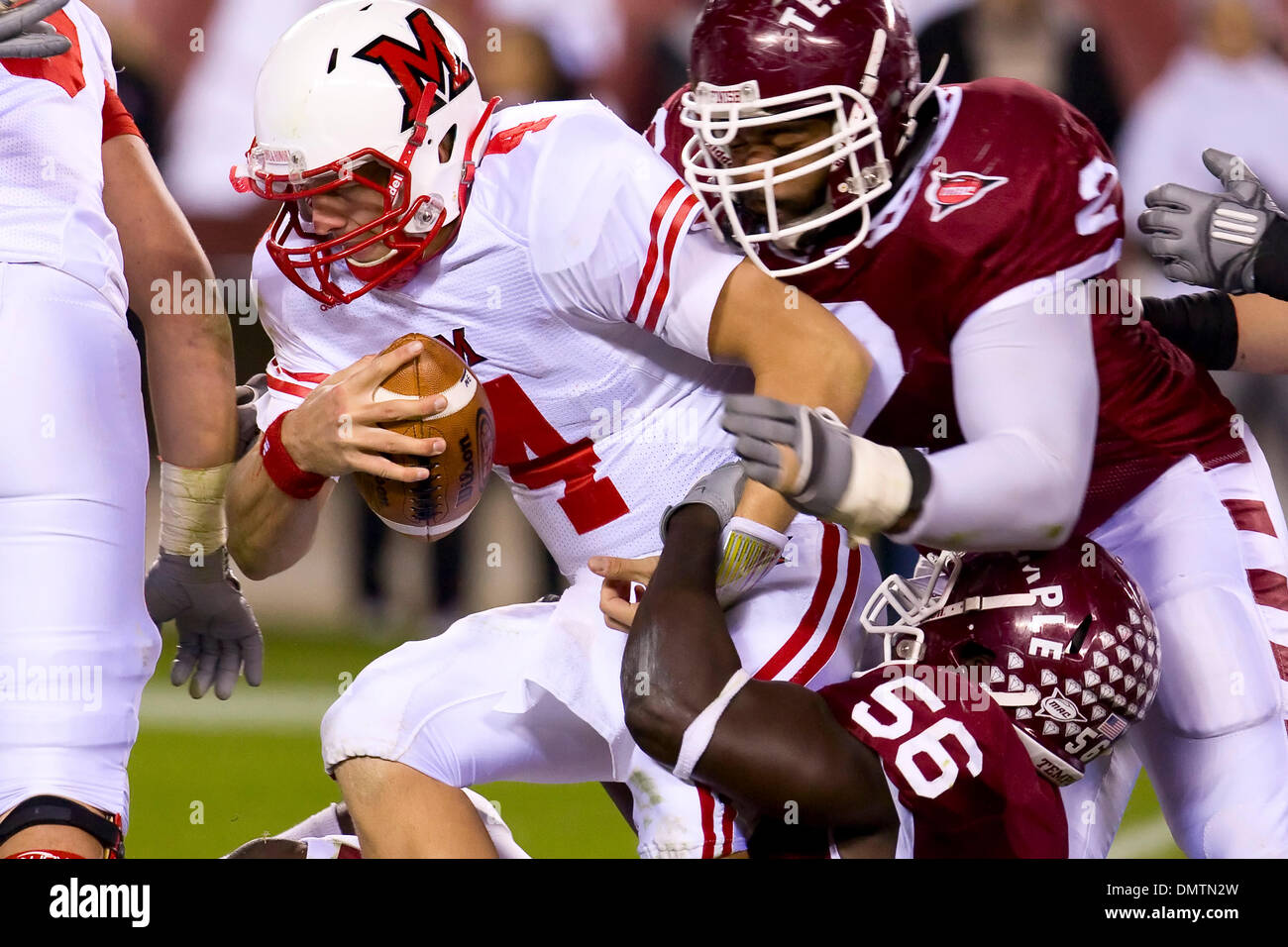 Miami RedHawks quarterback Zac Zysert (4) getting sacked by Temple Owls ...