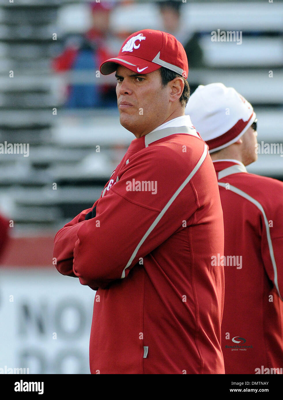 Washington St. head football coach Paul Wulff watches as his team warms ...