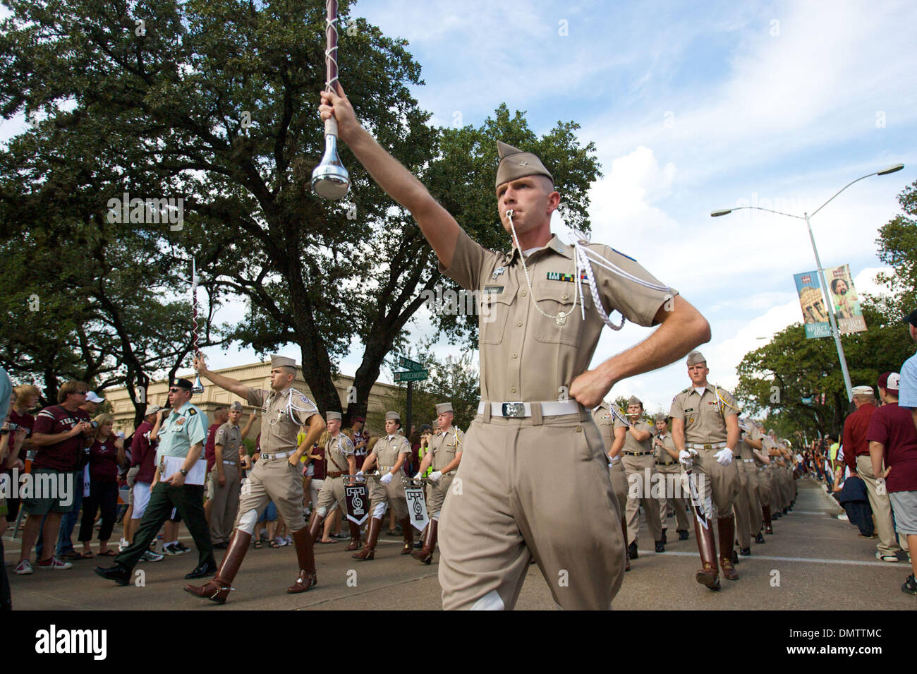 Head Drum Major of the Texas Aggie Band leads the band as they march in ...
