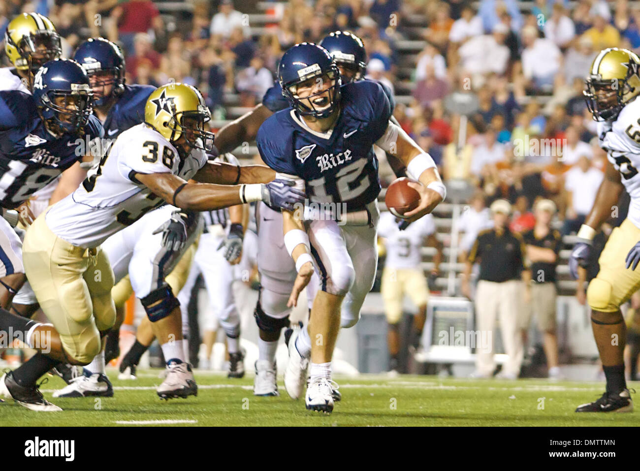 Ryan Lewis (#12) of the Rice Owls is nearly brought down by Sean ...