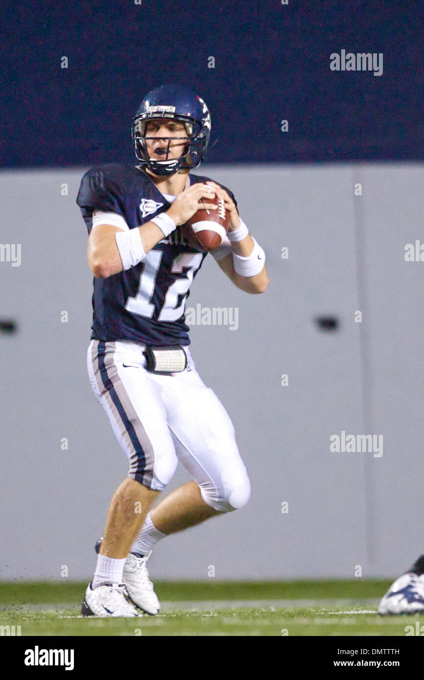 Ryan Lewis (#12) of the Rice Owls looks upfield for an open receiver ...