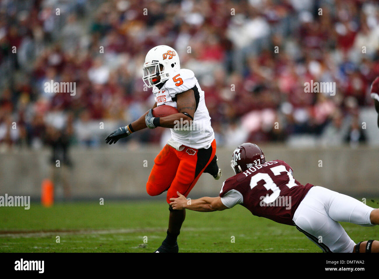 Keith Toston (#5) of the Oklahoma State University Cowboys slips past ...