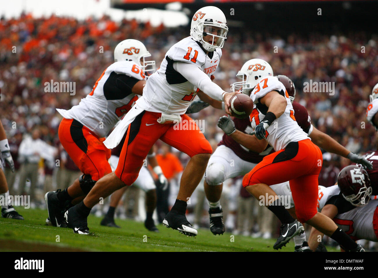 Zac Robinson (#11) of the Oklahoma State University Cowboys turns to ...