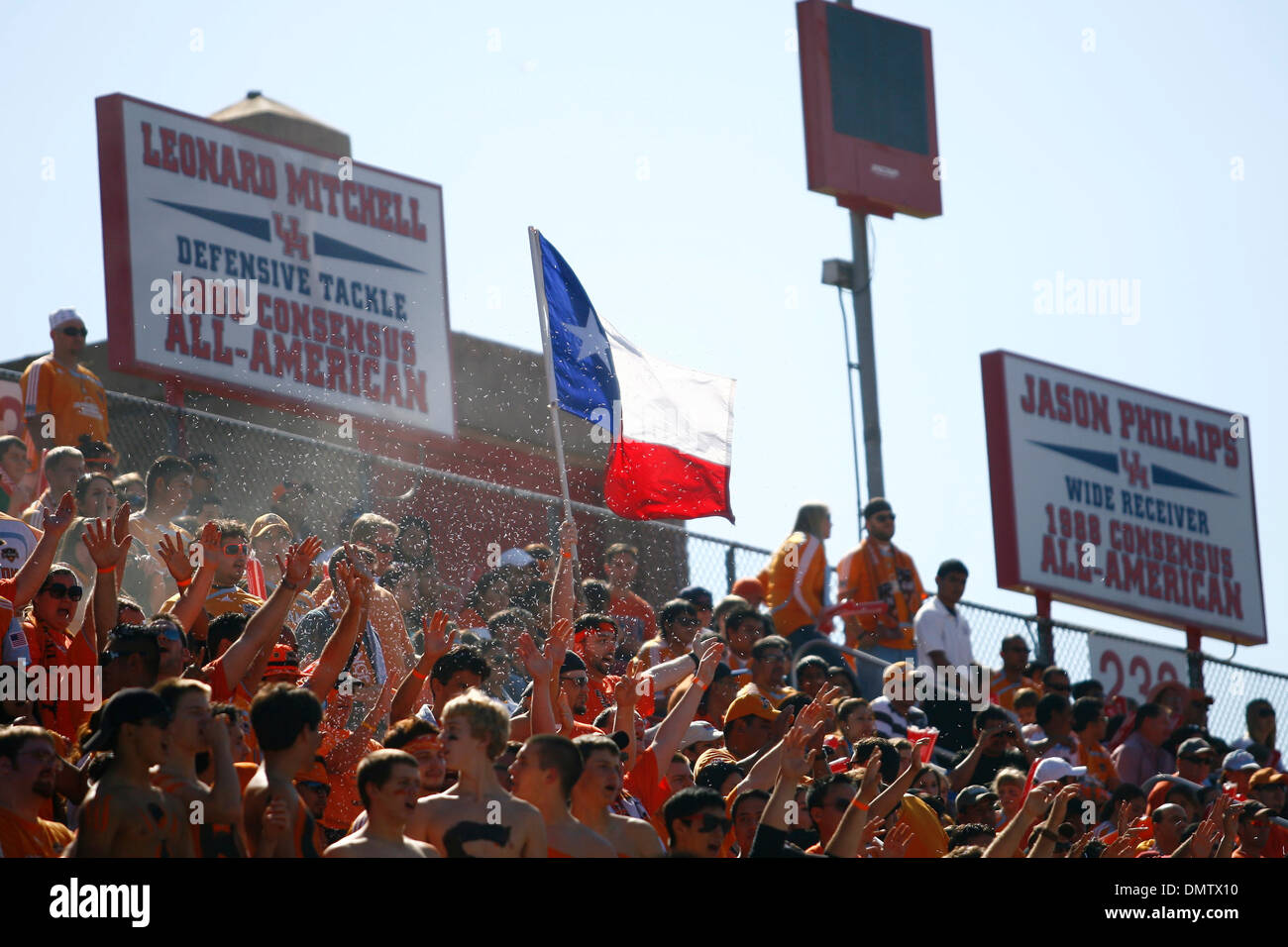 Houston Dynamo fans wave a Texas flag, hold their hands in the air, and ...
