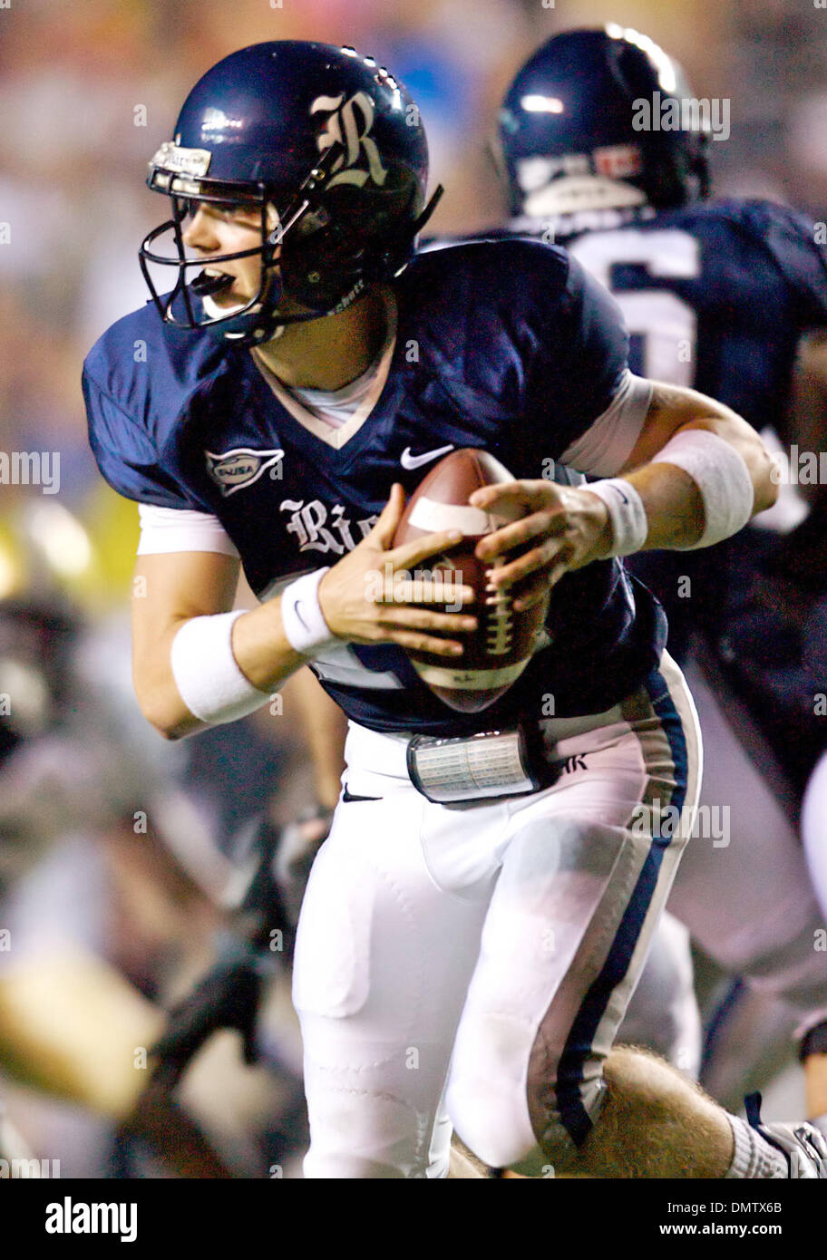 Ryan Lewis (#12) of the Rice Owls with the ball on the snap. The ...