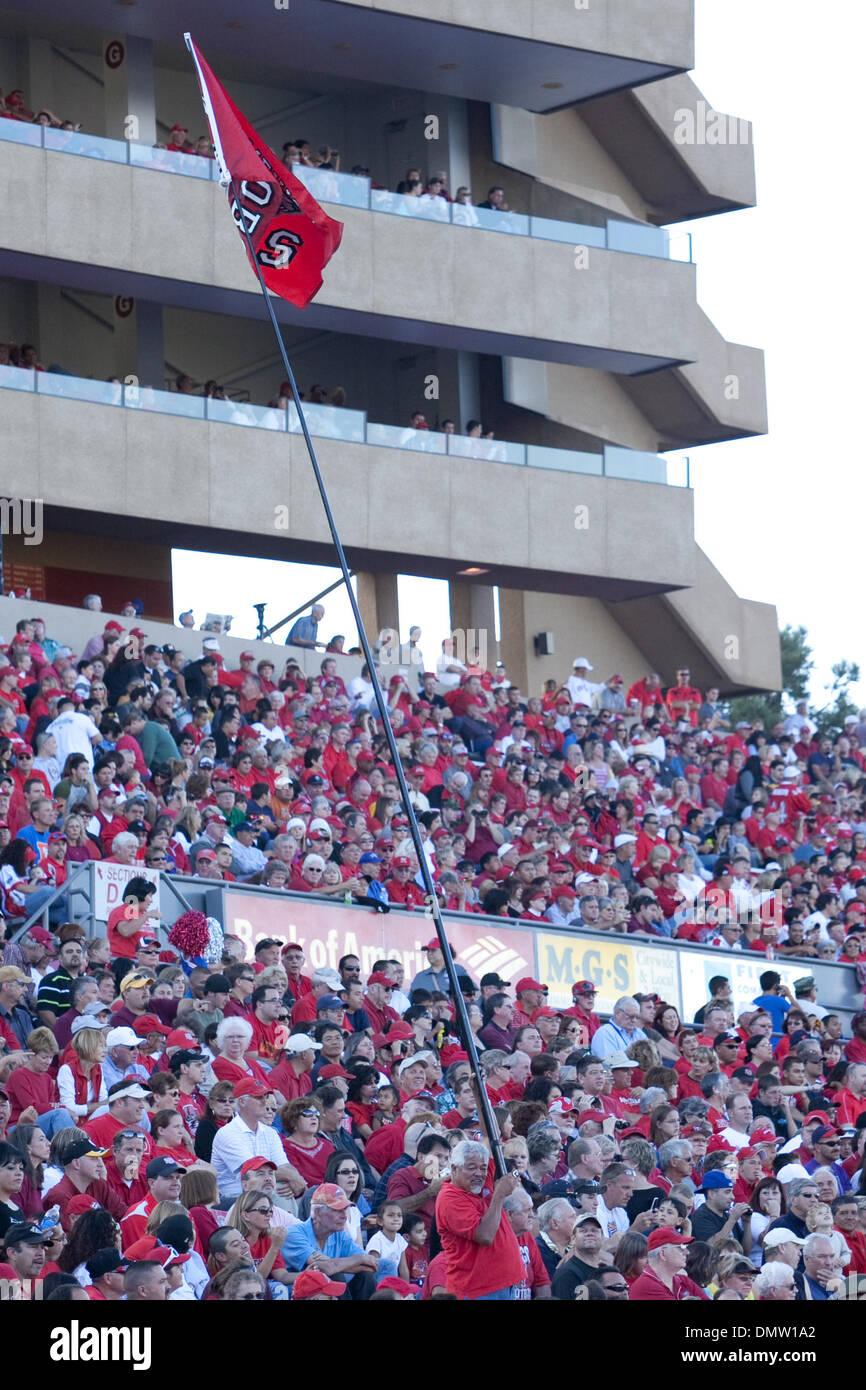 The University of New Mexico fan waves the Lobo flag two stories high ...