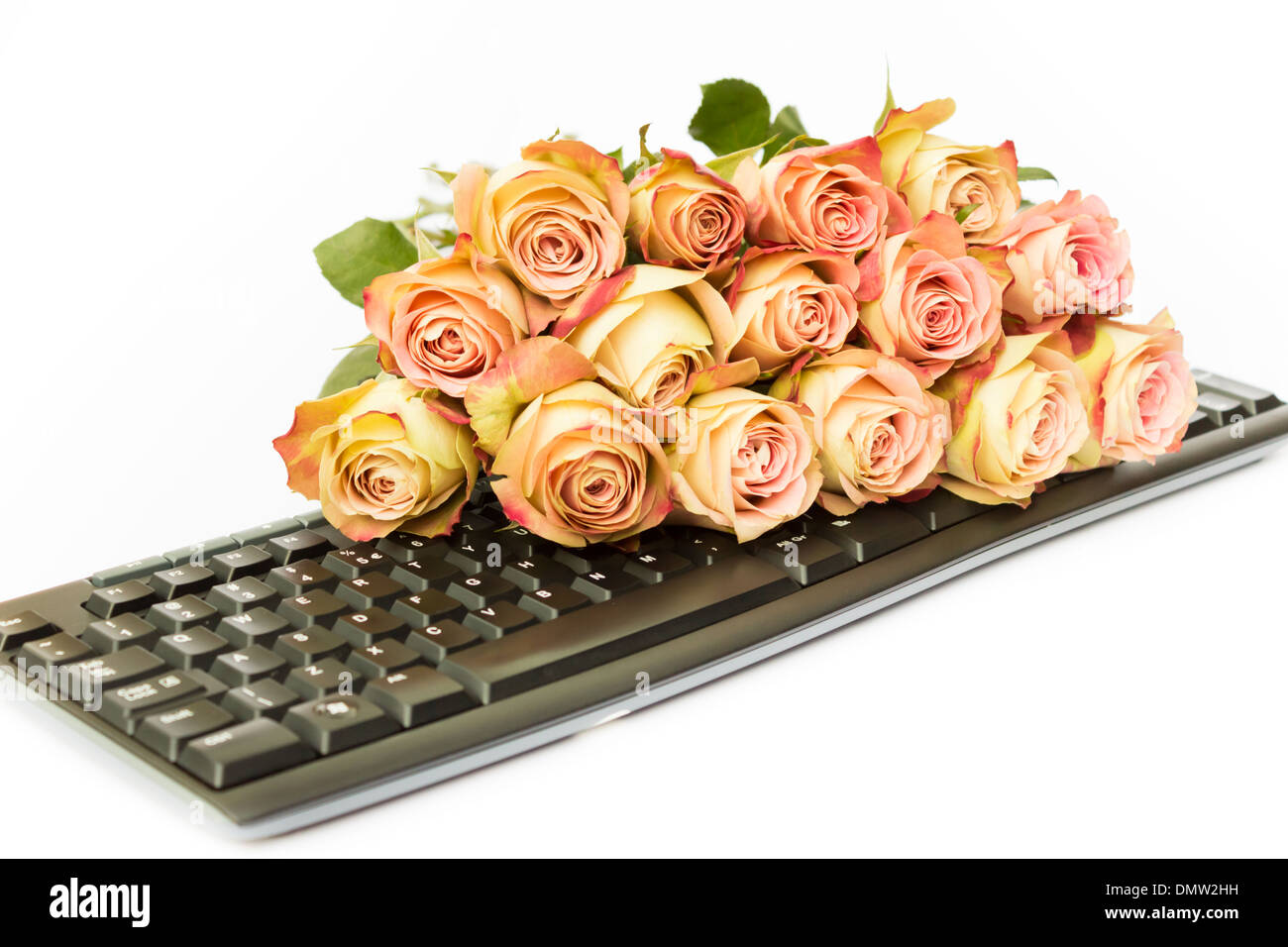 Bouquet of pink roses on computer keyboard Stock Photo - Alamy