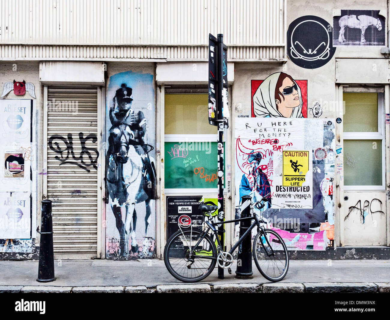 Graffiti, street art, stickers and posters on a wall in Fashion Street ...