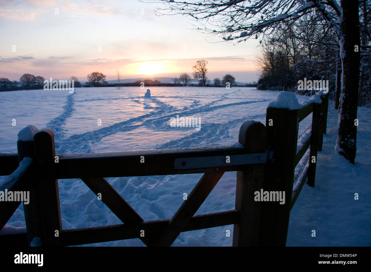 Snowman in snowy field at sunrise Stock Photo - Alamy