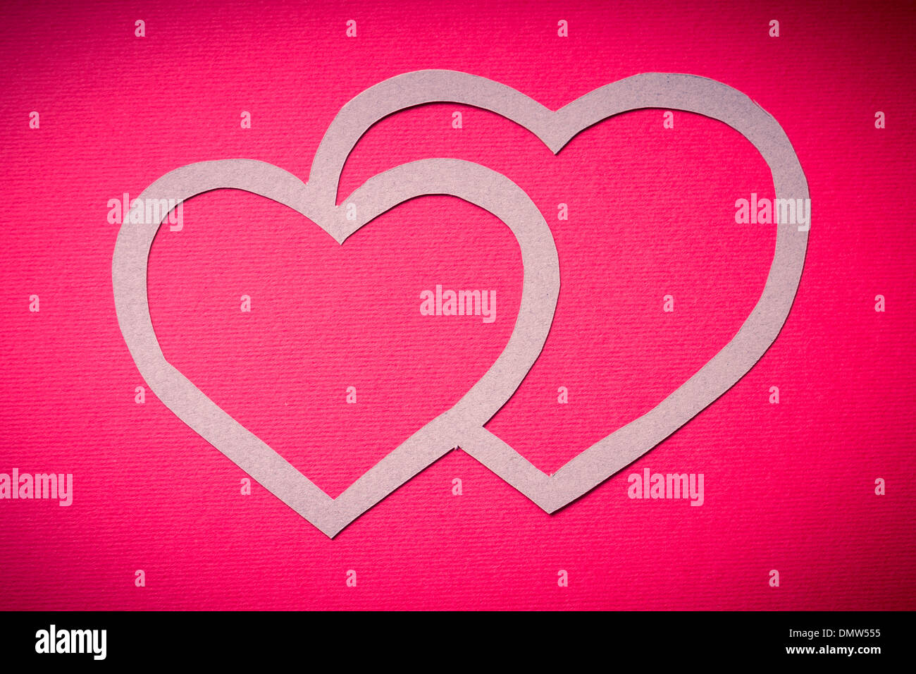 Twin Heart Shape on Red Background. Cut out from paper Stock Photo - Alamy