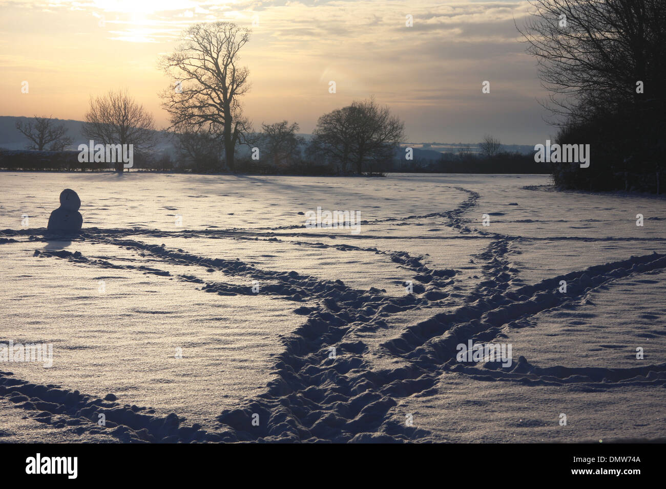 Snowman in snowy field at sunrise Stock Photo - Alamy