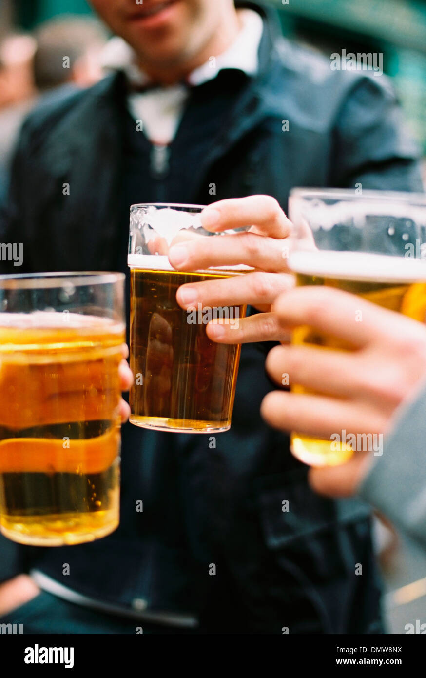 Three guys toasting drinks hi-res stock photography and images - Alamy