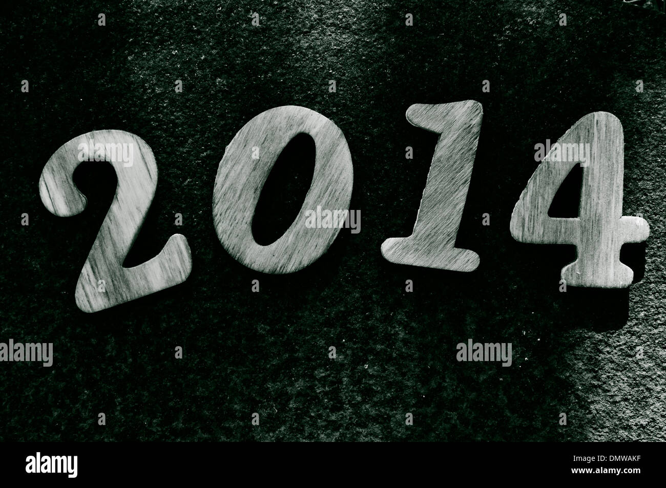 wooden numbers forming number 2014, as the new year, on a textured ...