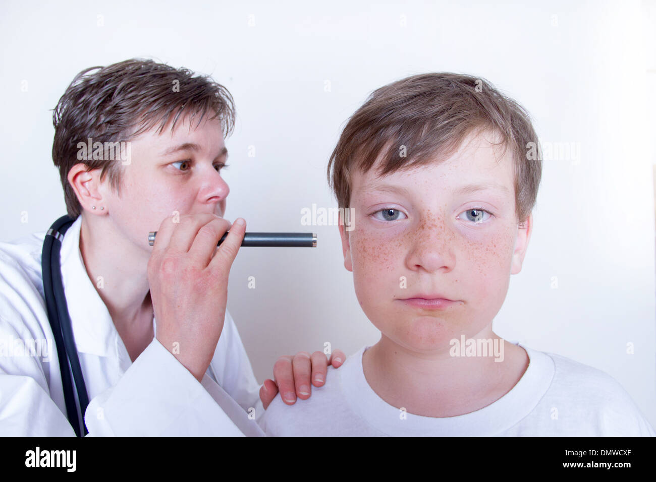 woman doctor examines a ear of a young boy Stock Photo - Alamy