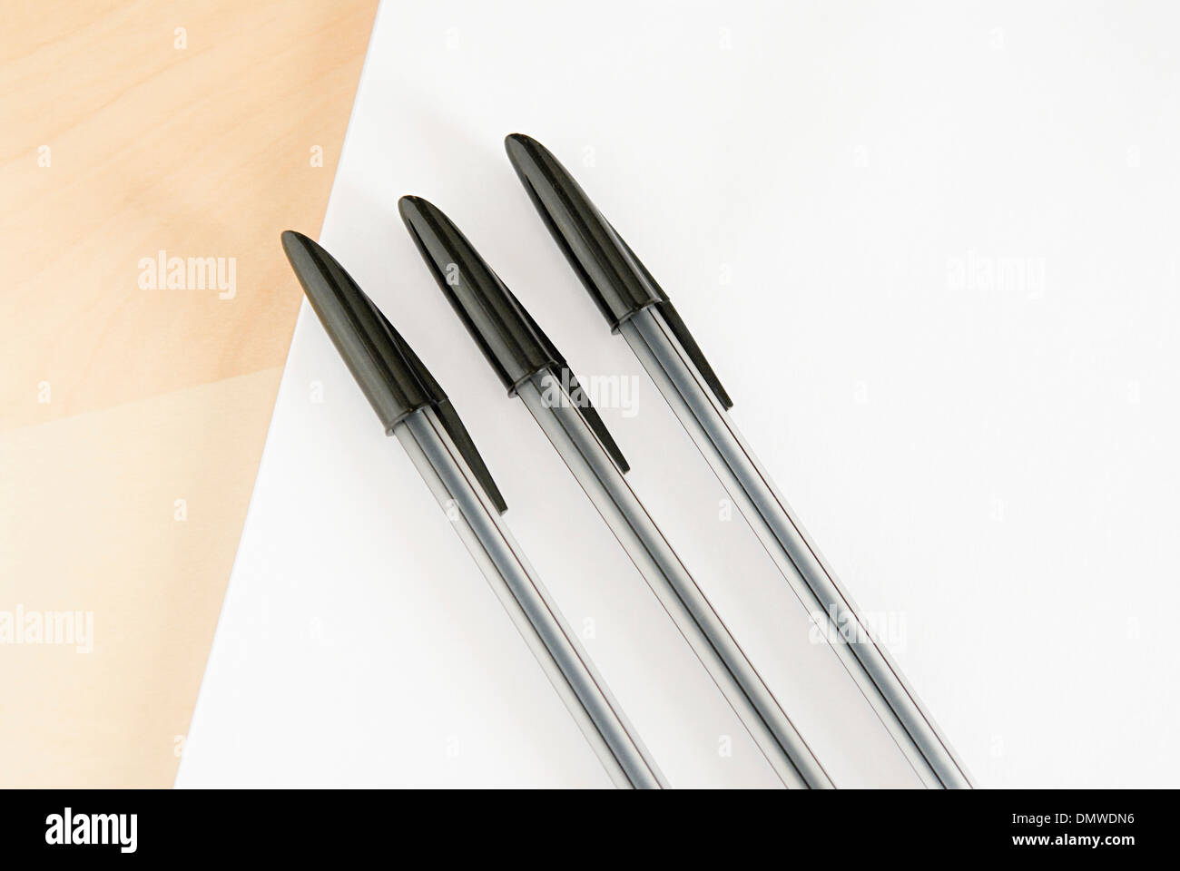 Three ball point pens lined up in a row on a white background Stock ...