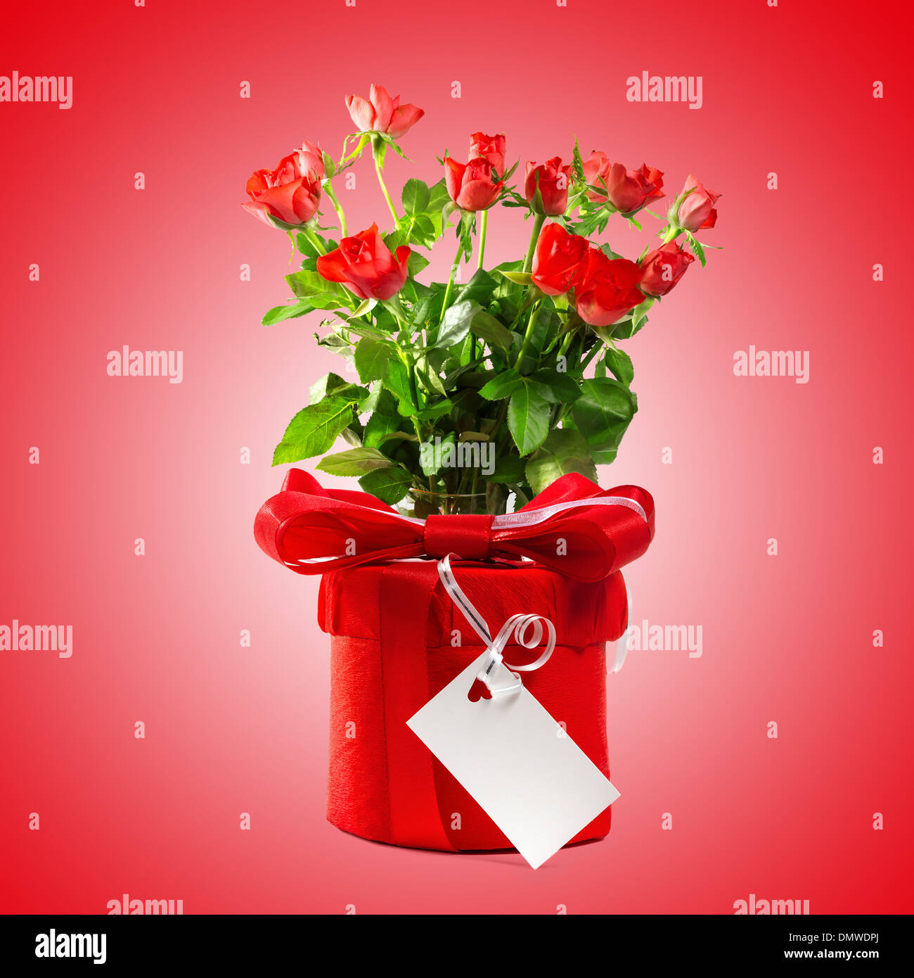 Red gift with a red bow and roses Stock Photo - Alamy