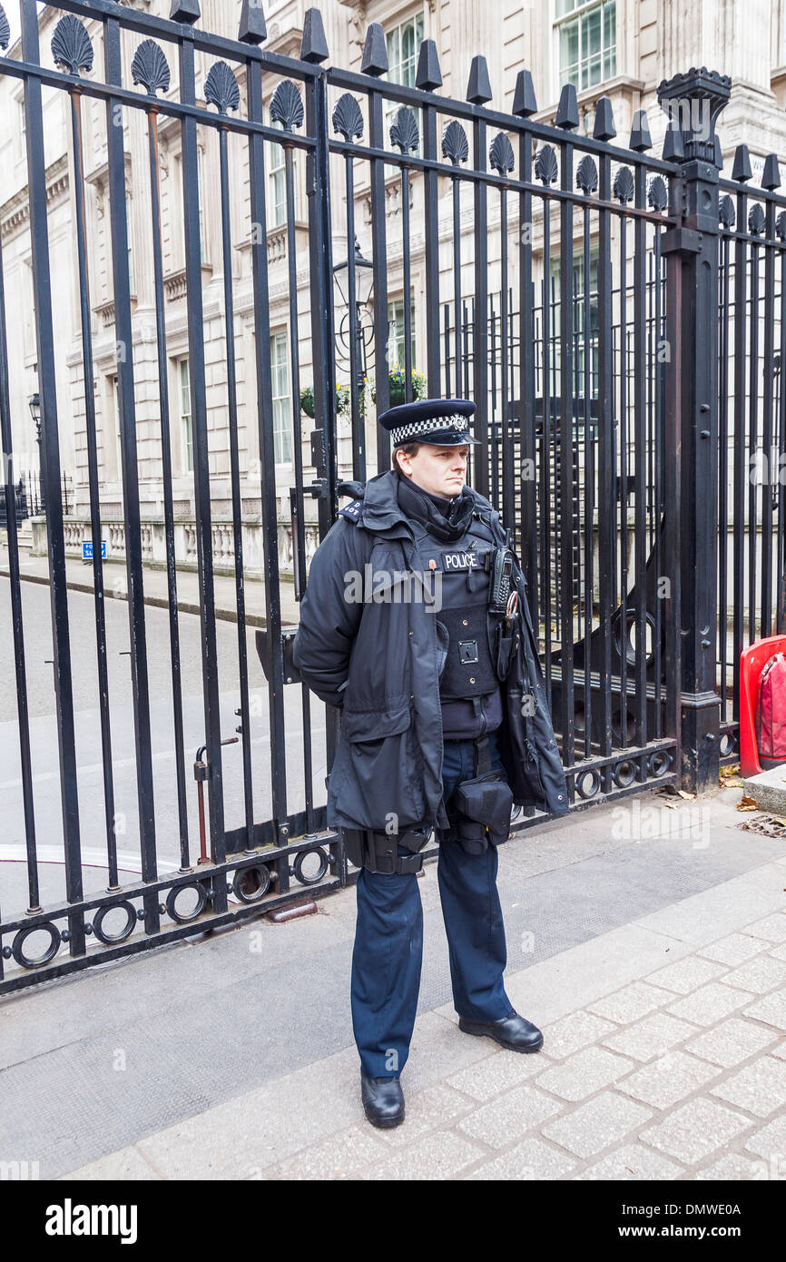 London, Whitehall A policeman guarding the gates of Downing Street ...