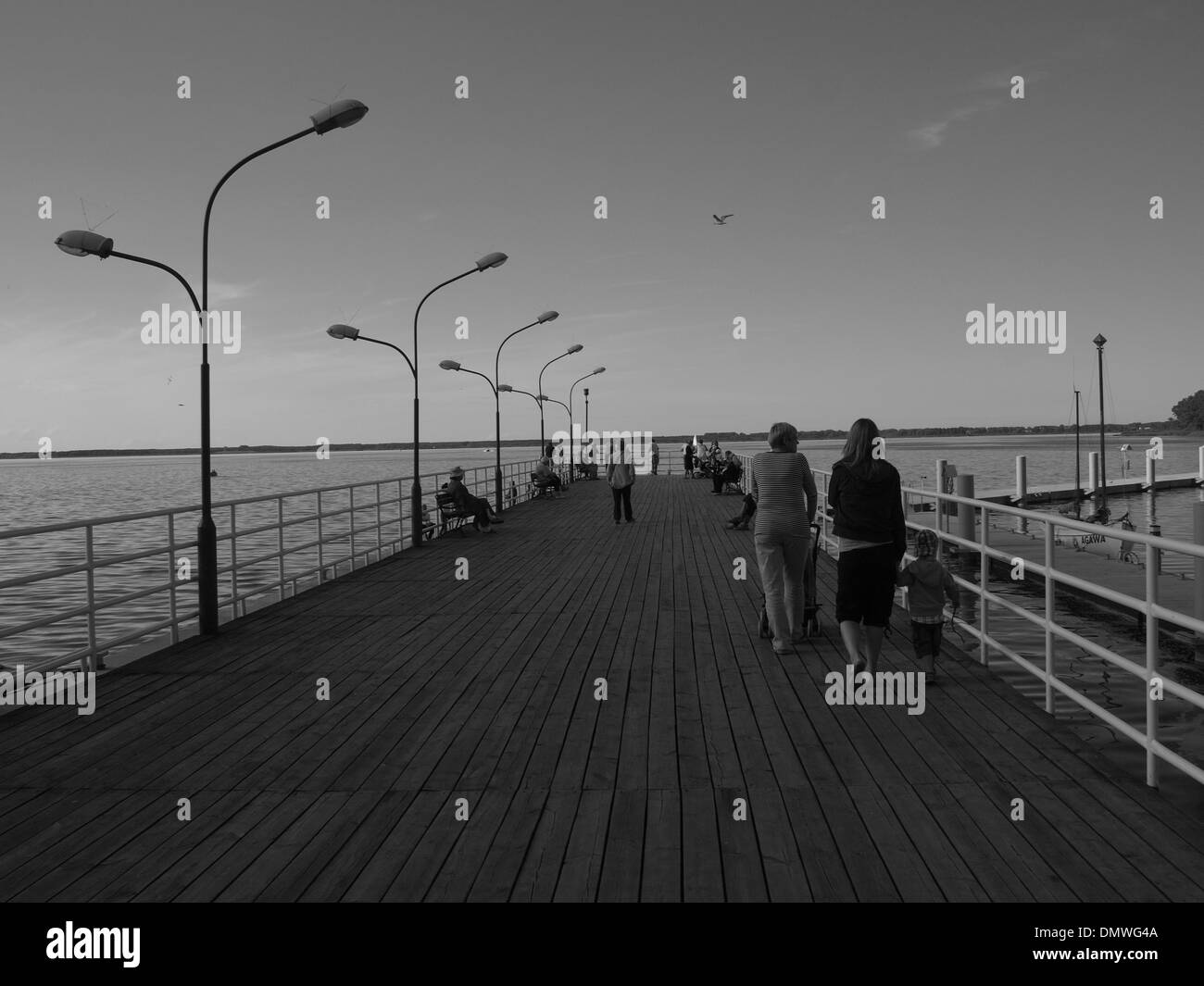 People strolling on a pier Stock Photo - Alamy