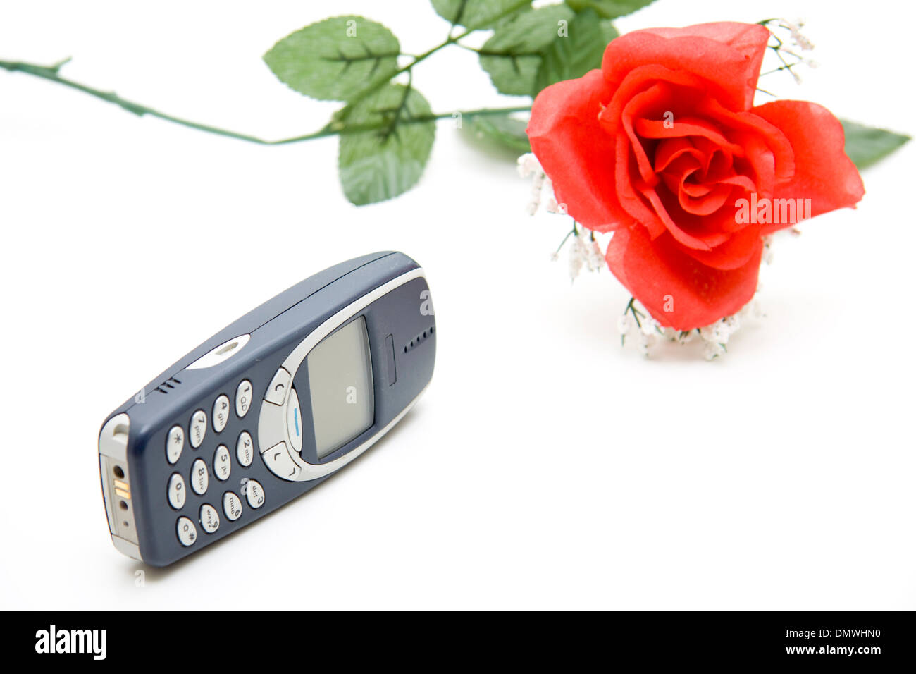 Mobile phone with red rose Stock Photo - Alamy