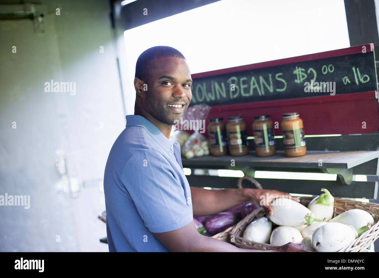 An organic fruit and vegetable farm. A man sorting vegetables Stock ...