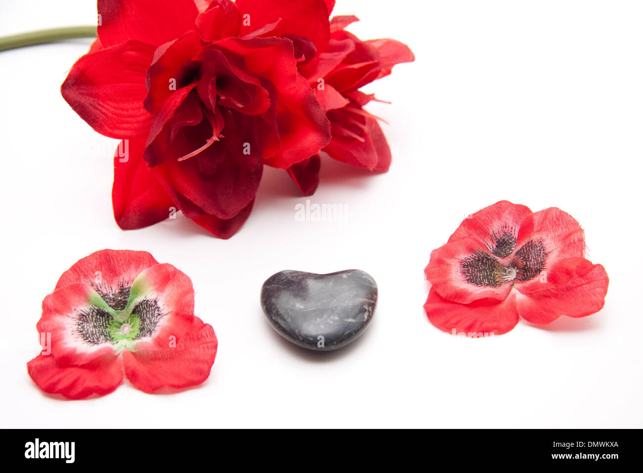 Heart stone with flower blossom Stock Photo - Alamy