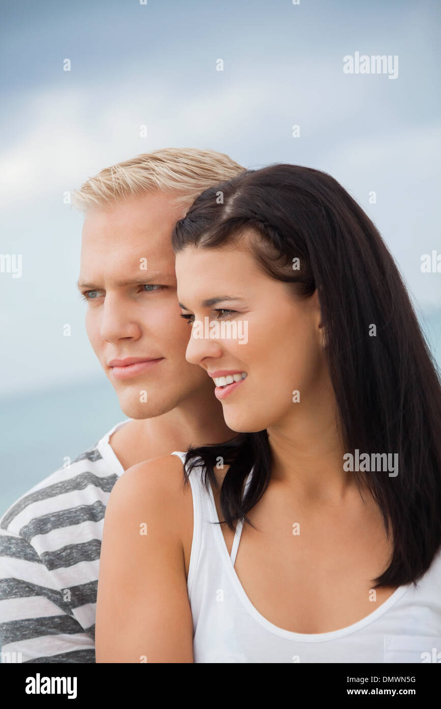 Loving couple enjoy a quiet tender moment as they stand in a close ...