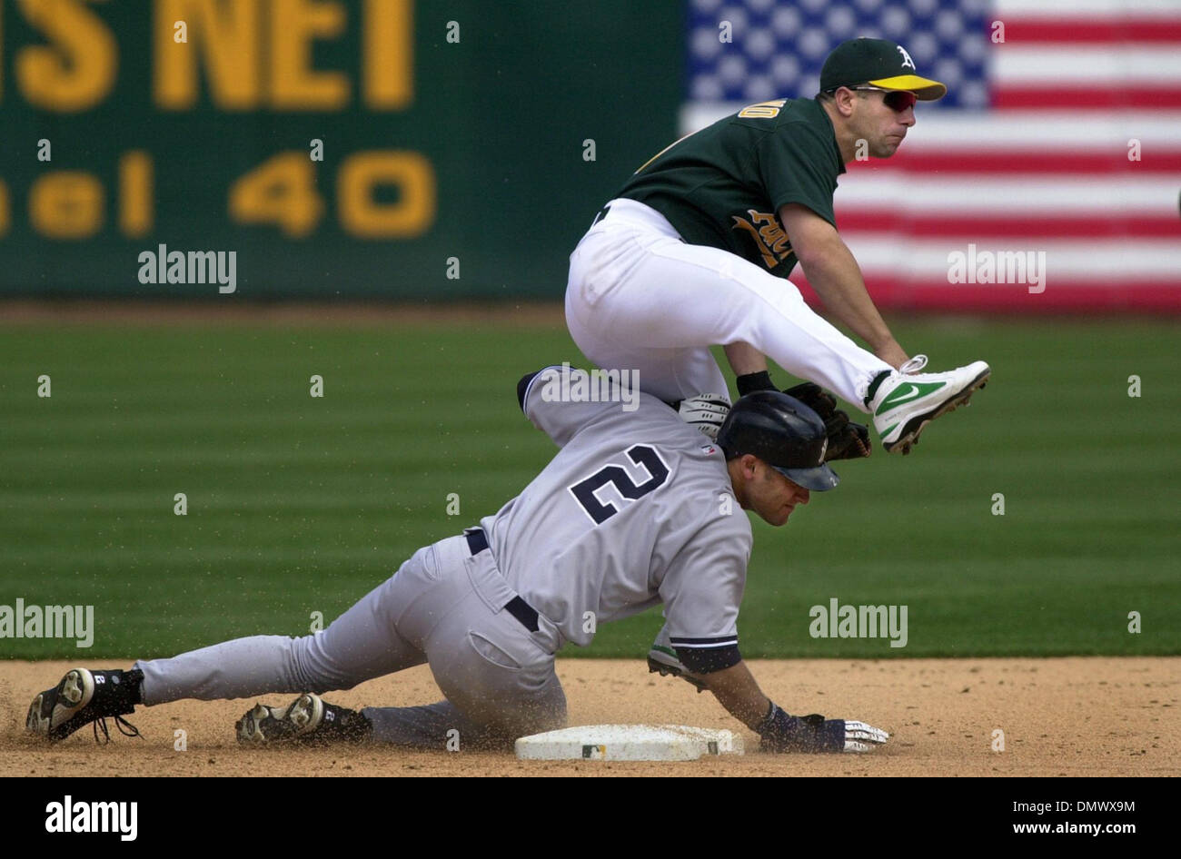 Apr 25, 2002; Oakland, CA, USA; A's #11 Frank Menechino (top) turns a ...