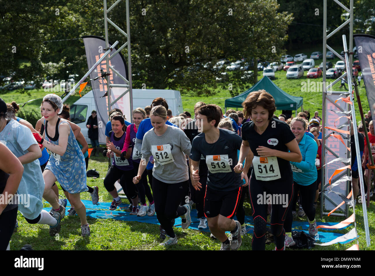 Competitors running through the starting line of an endurance trial ...